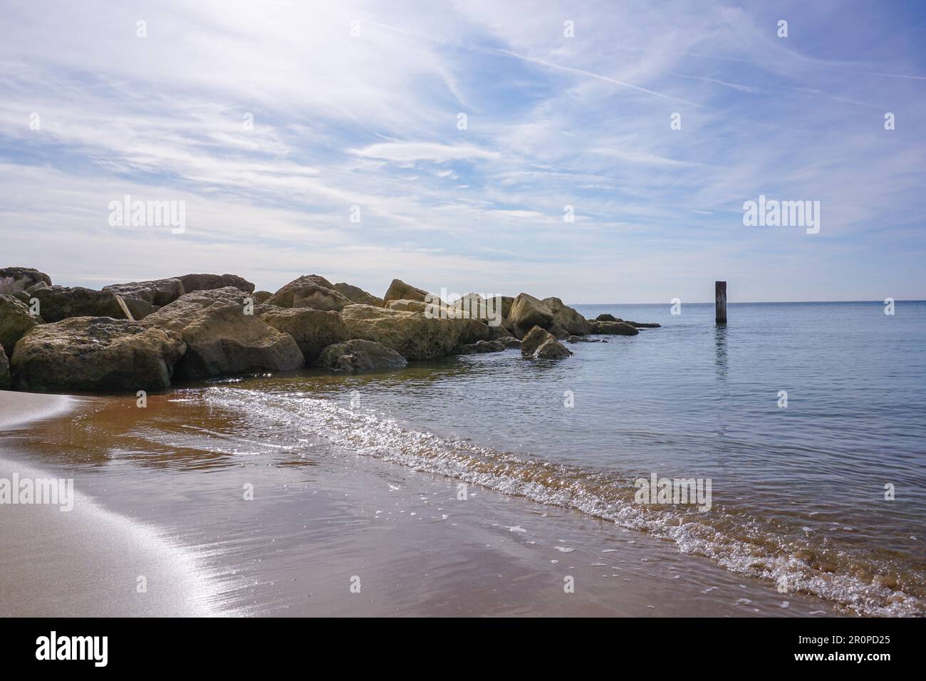 coastal landscape viewed from sandy beach. Looking out to sea with rock ...
