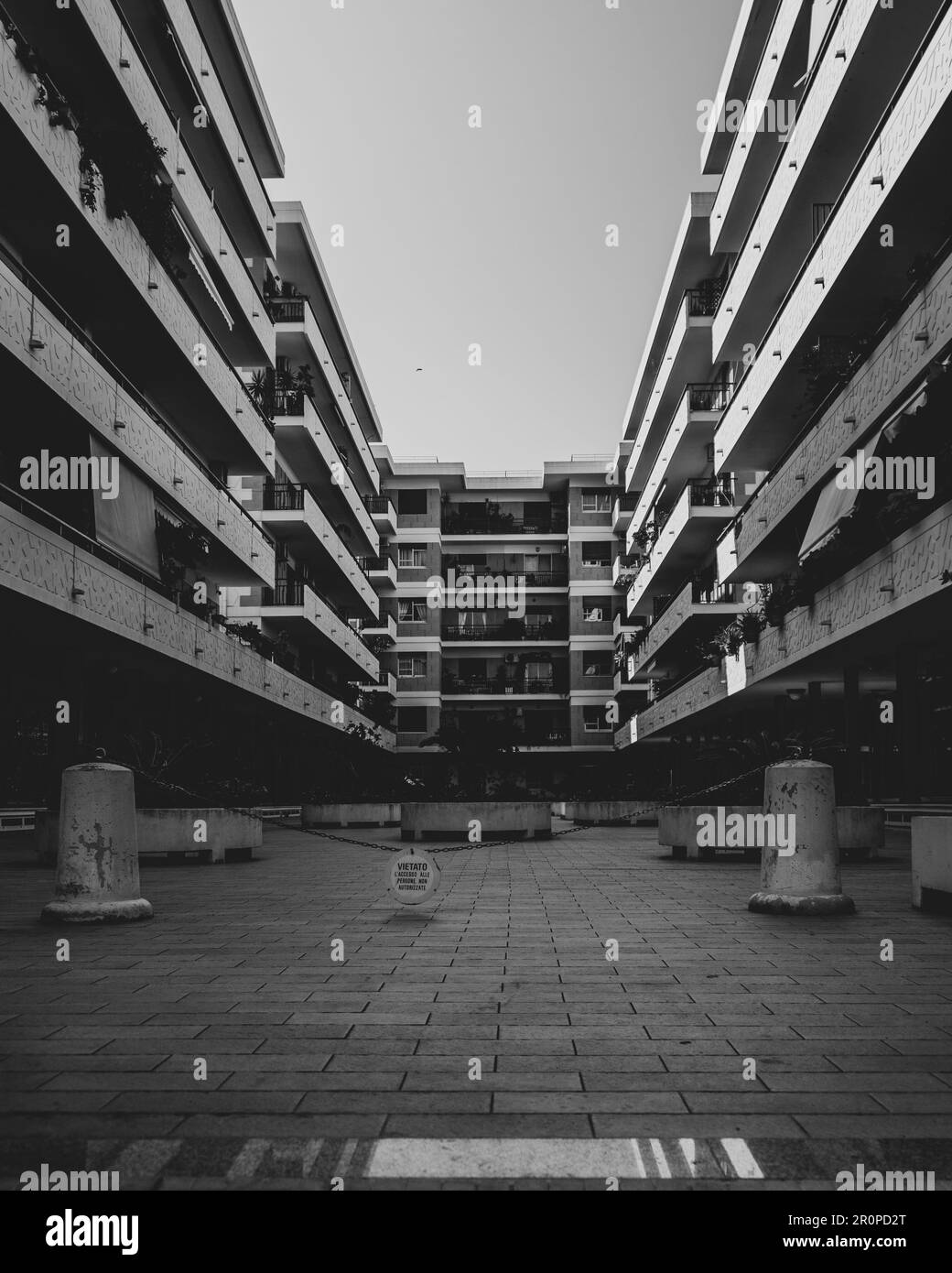 A monochrome shot of the tall modern residential complex with an ...