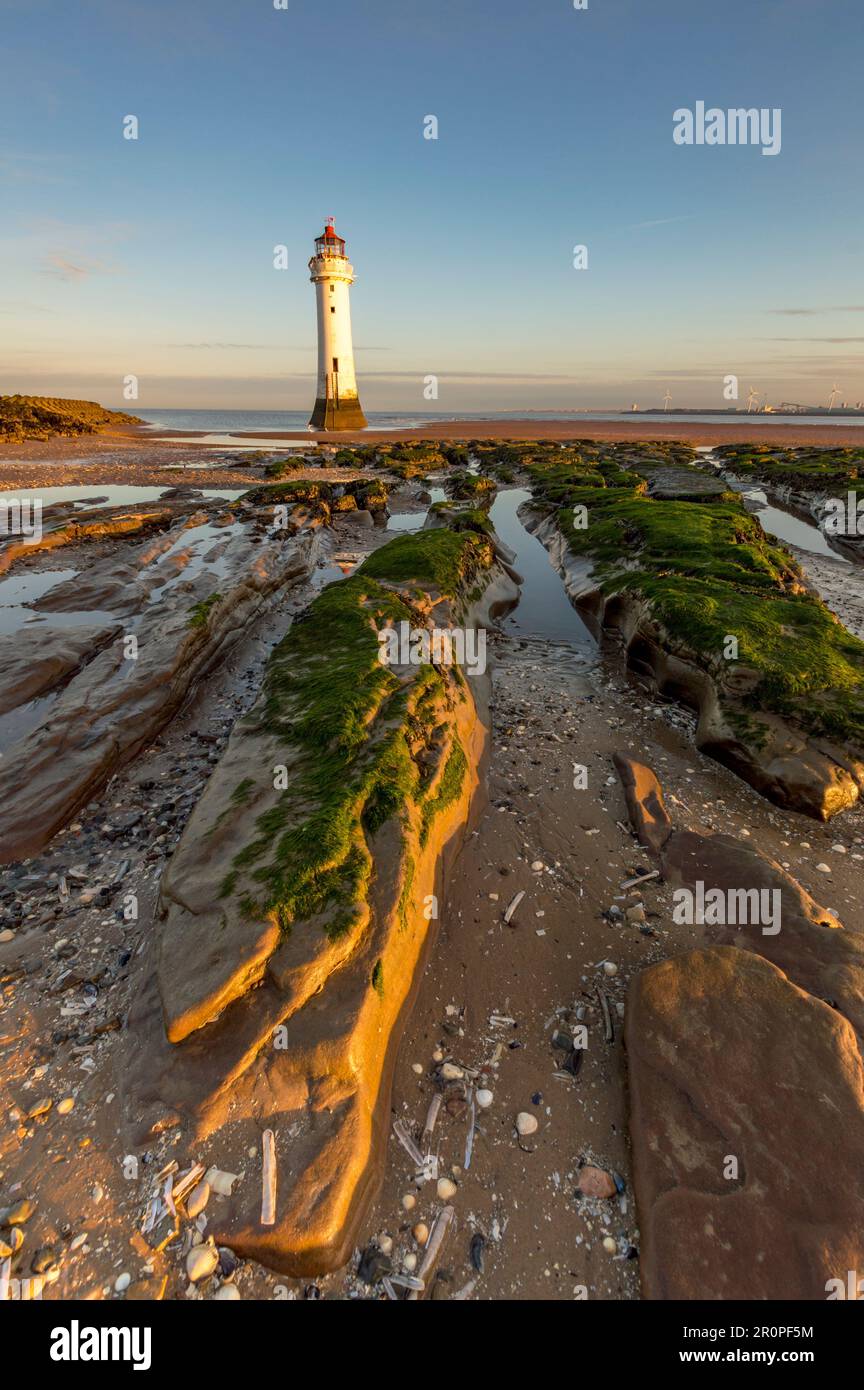 A stunning twilight scene featuring a rocky beach and an iconic New ...