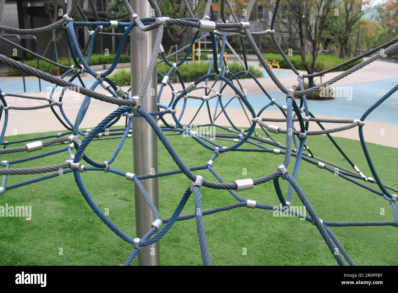 A play area, featuring a climbing net and a turf lawn grass Stock Photo ...