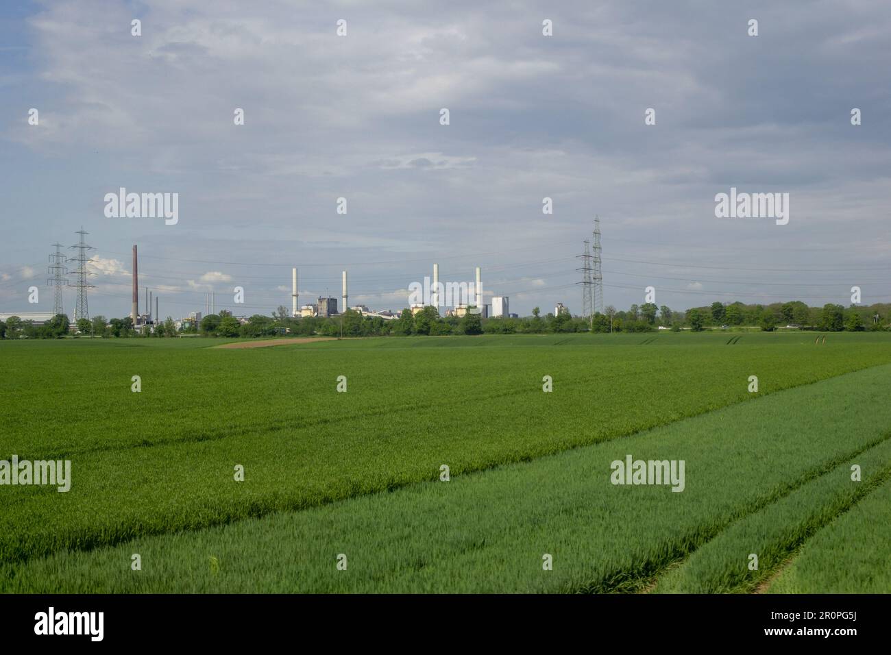 field with production in the background Stock Photo - Alamy