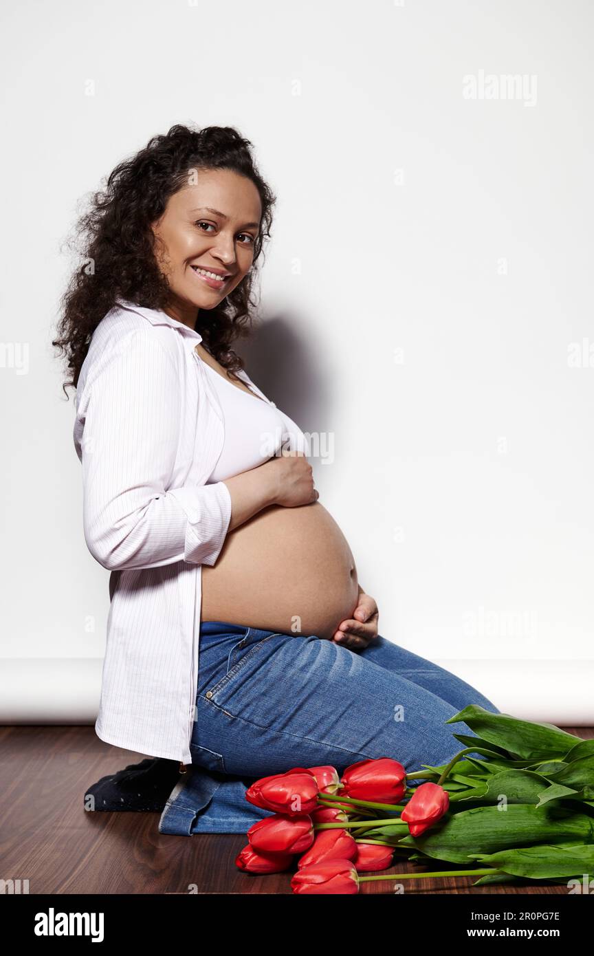 Ethnic Curly Happy Adult Pregnant Woman Holding Hands On Belly