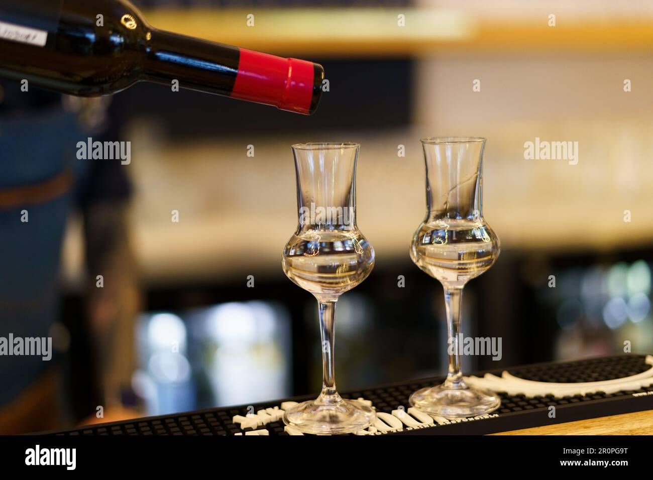 Brandy Pour from a bottle into Brandy Glasses In Bar Stock Photo - Alamy