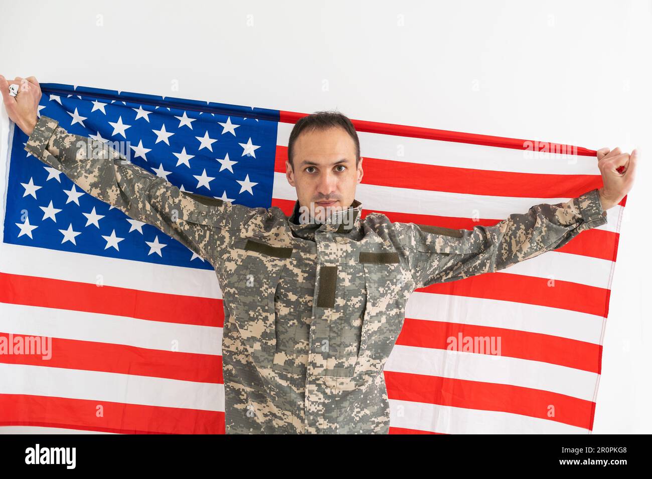 Army soldier holding stars and stripes national flag hi-res stock ...