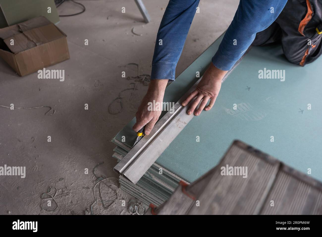 Construction worker installation ceiling work Stock Photo - Alamy