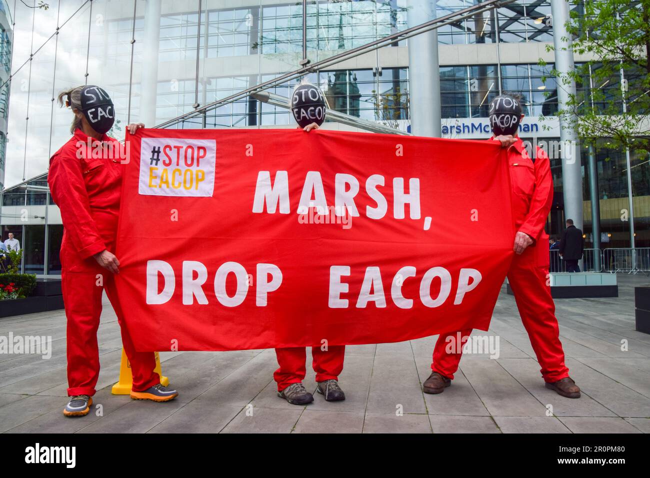 London, UK. 09th May, 2023. Activists wearing 'Stop EACOP' masks hold ...
