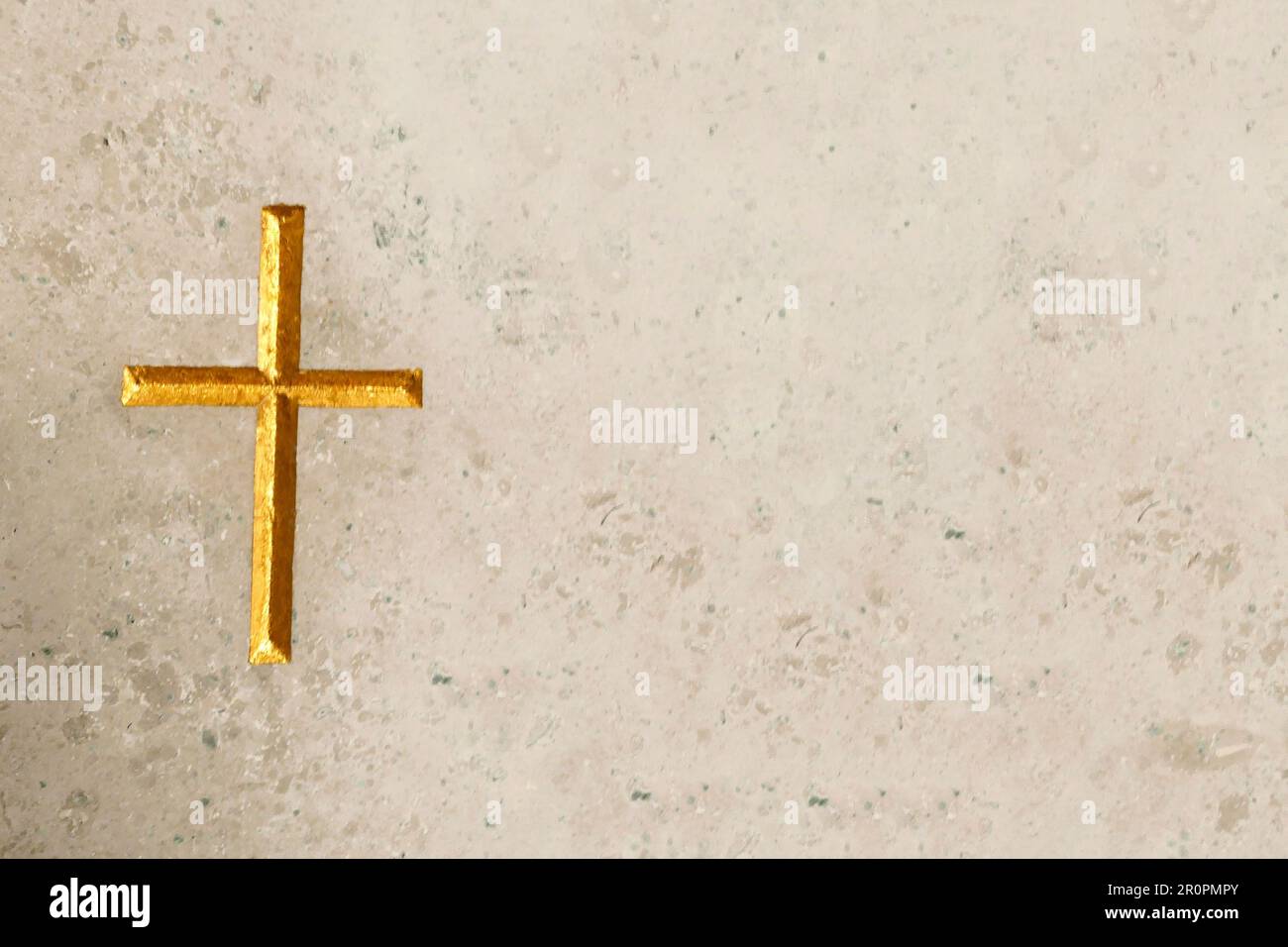 Golden cross engraved in beige marble. With copy space. Meant as ...