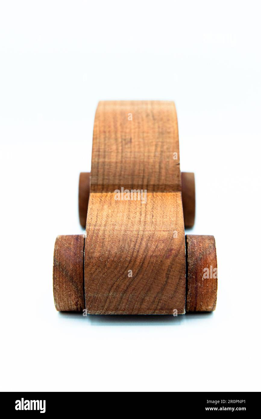 front view of a wooden toy car made from cherry wood, isolated on a ...