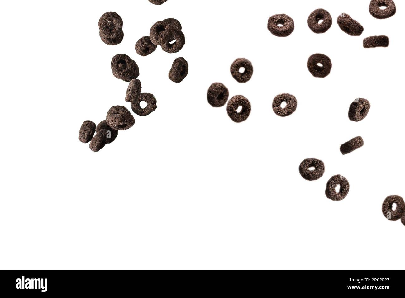 Chocolate rings cereal spill out into a bowl. Breakfast. Isolated on a ...