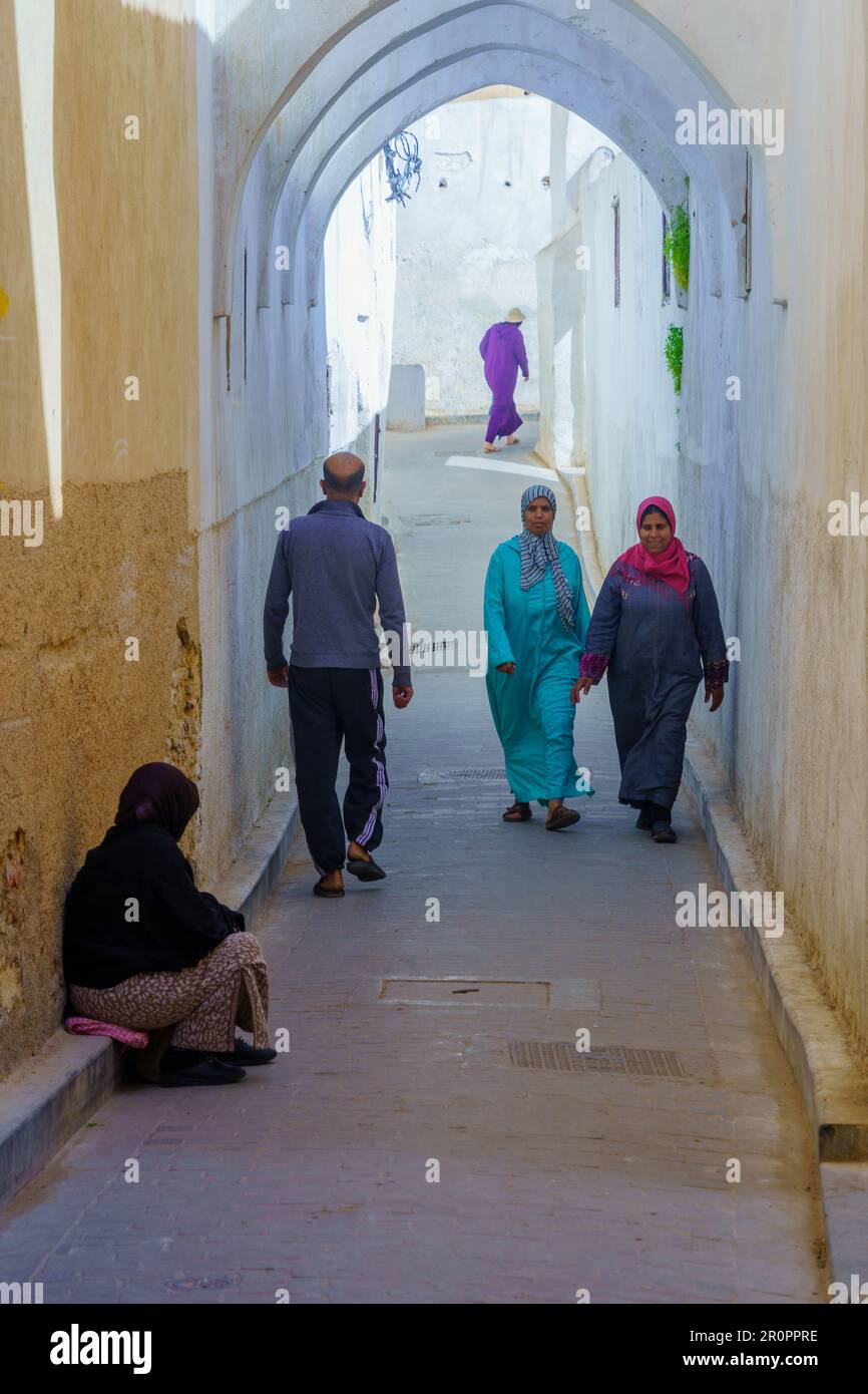 Fes, Morocco - March 31, 2023: View of an alley with arches and locals ...