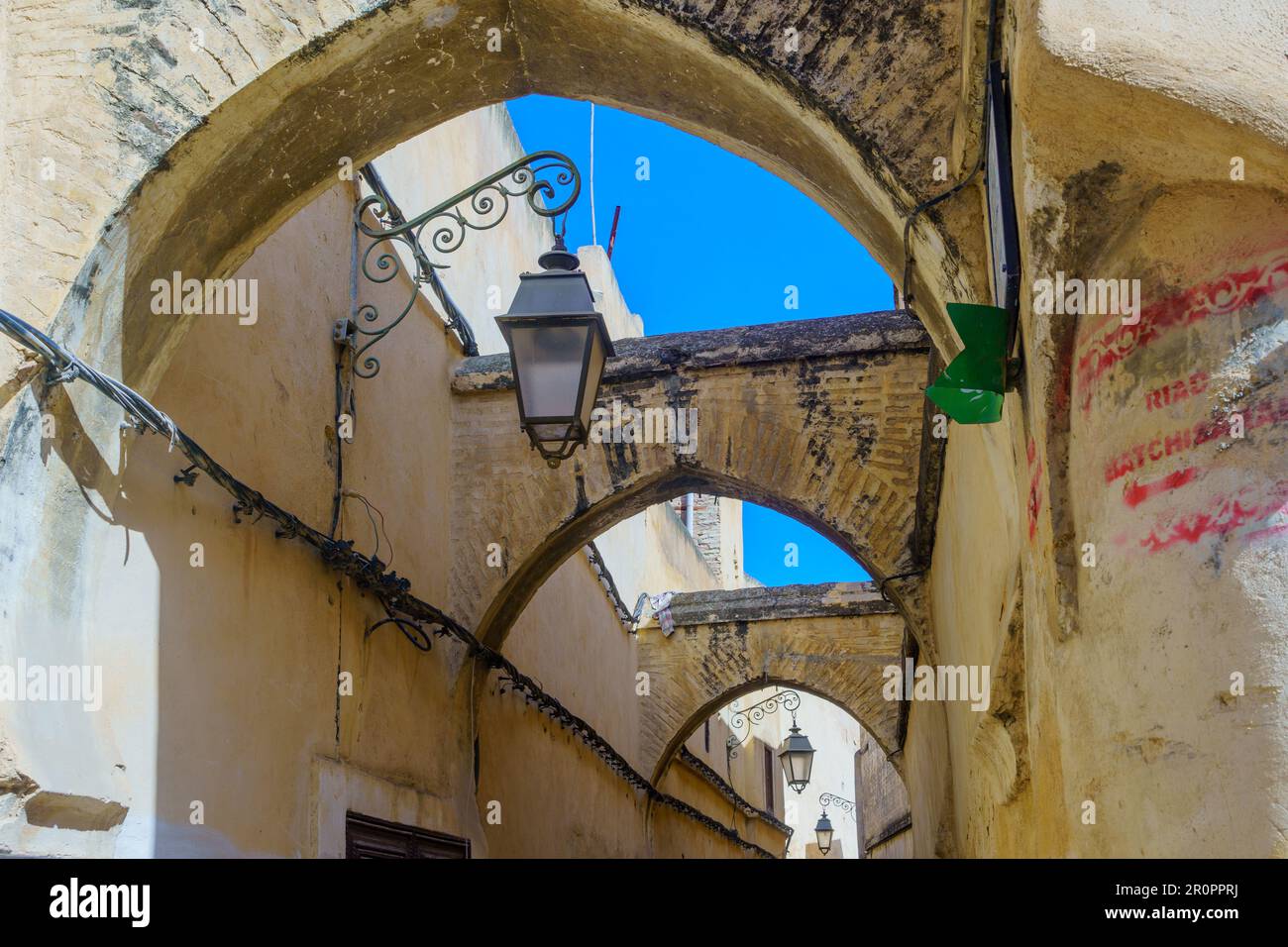 Fes, Morocco - March 31, 2023: View of an alley with arches and ...