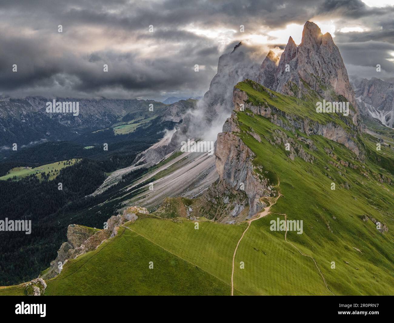 Mount Seceda in the Dolemites during a beautiful foggy morning. Iconic ...