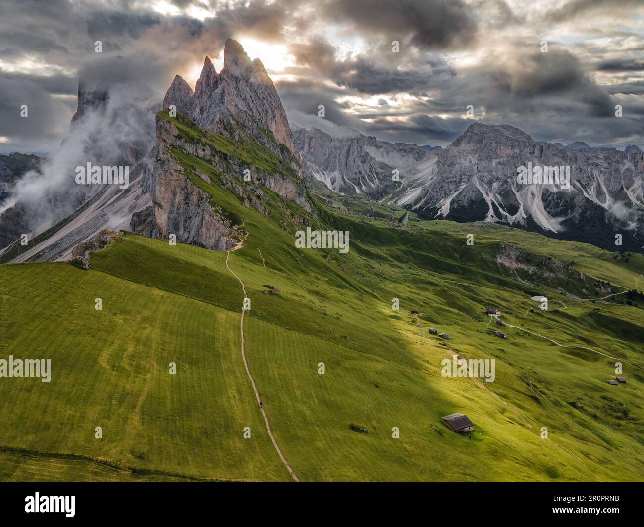 Mount Seceda in the Dolemites during a beautiful foggy morning. Iconic ...