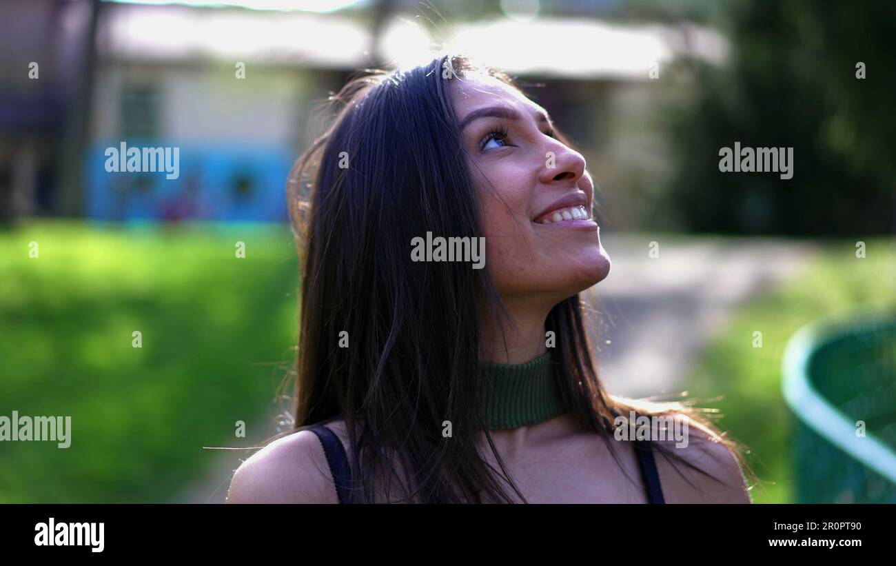 One hopeful Arab adult girl looking up at sky with Faithful gaze ...