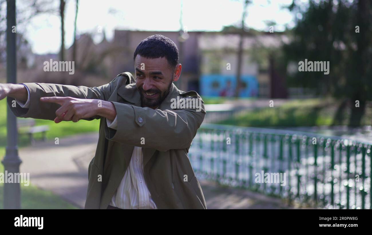 One Elated young man celebrates life feeling joy and happiness dancing ...