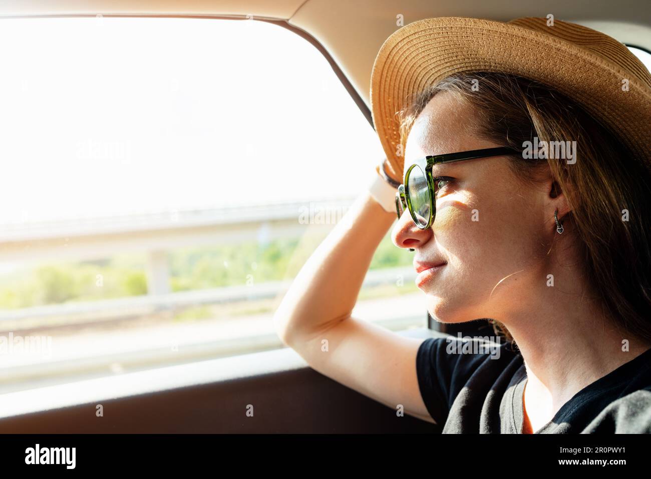 Woman sitting in car and looking out the window, taxi service Stock ...