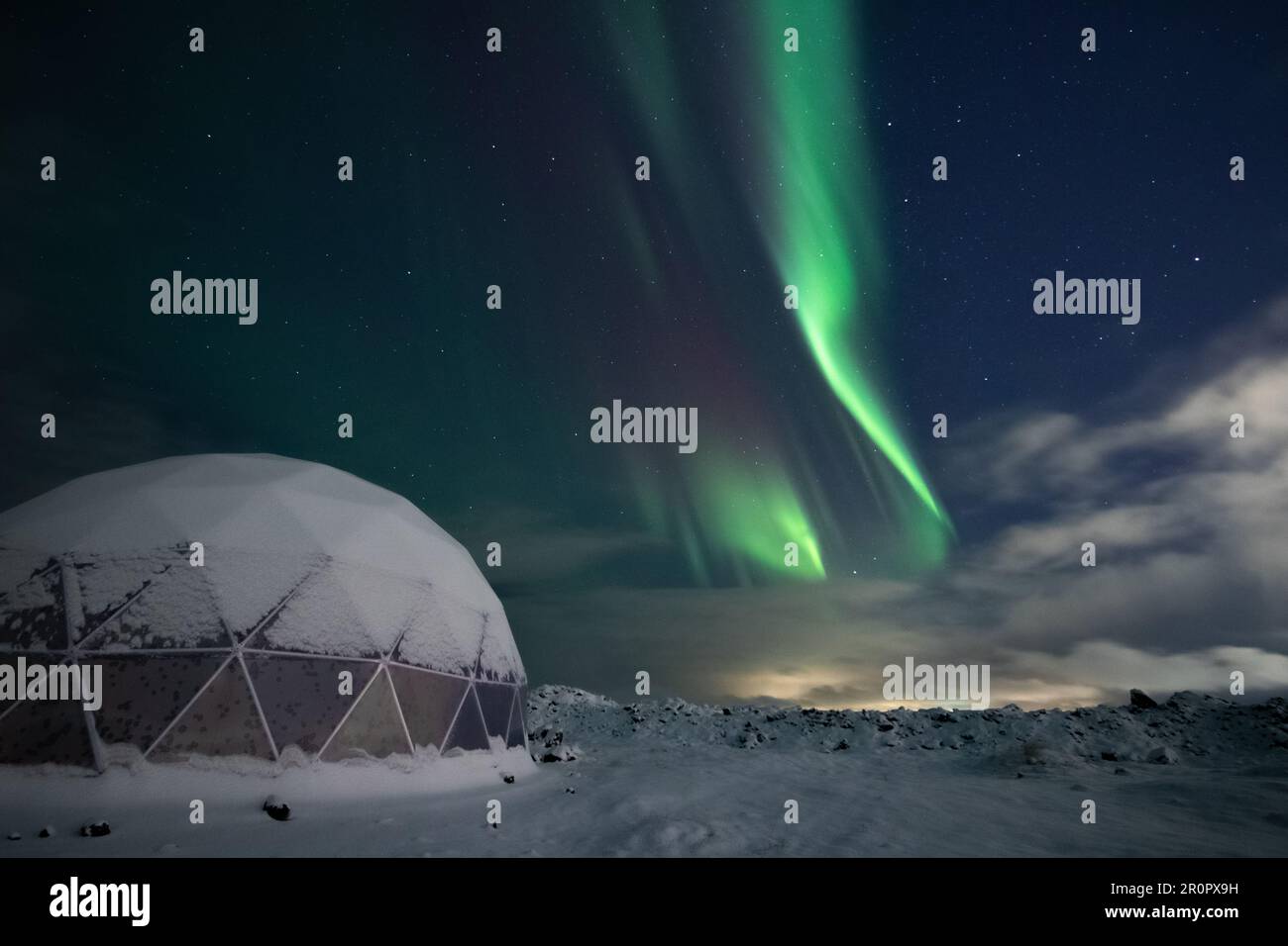 A modern igloo structure illuminated the northern lights Stock Photo ...