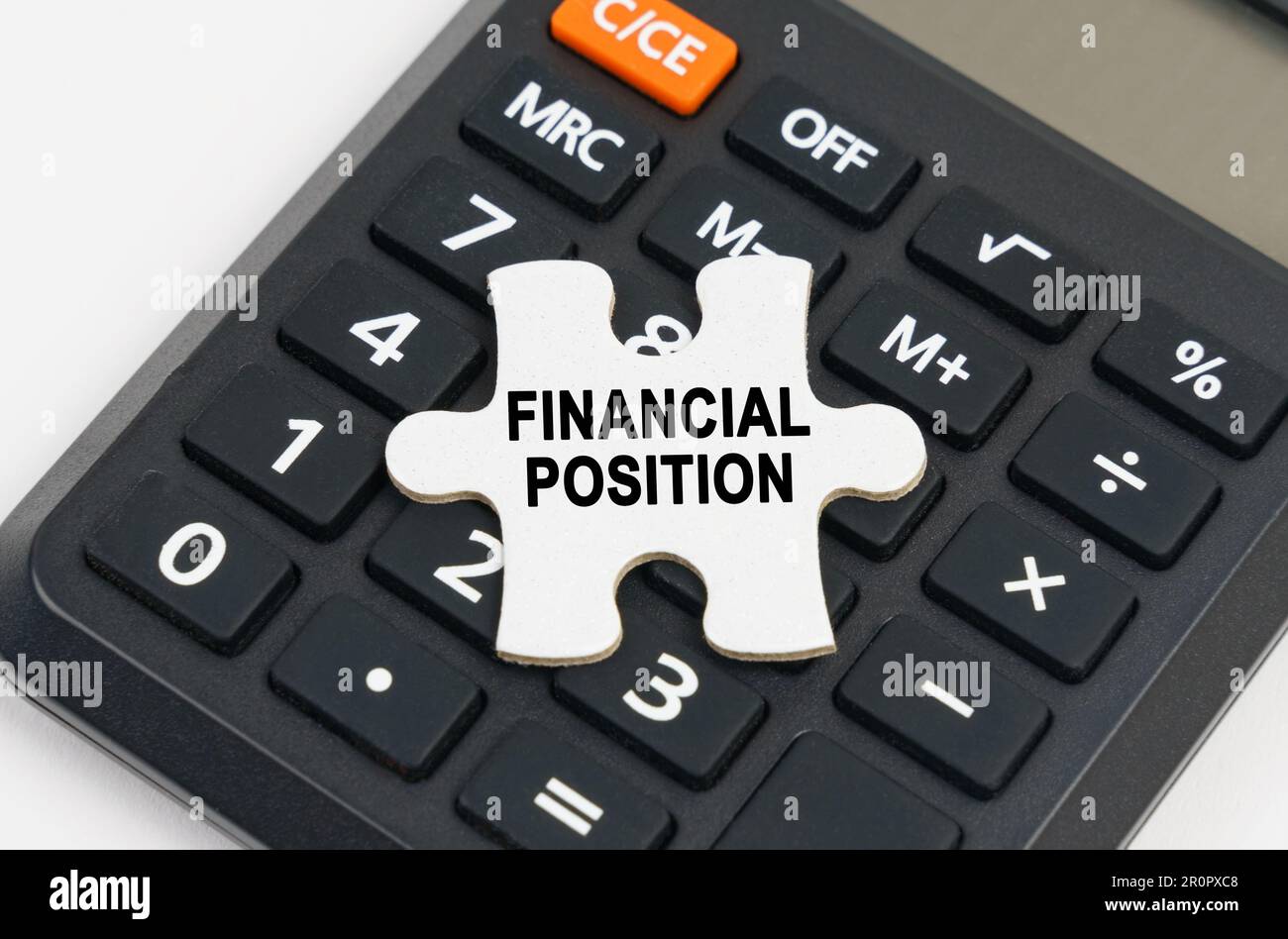 Business concept. On the calculator is a puzzle with the inscription ...