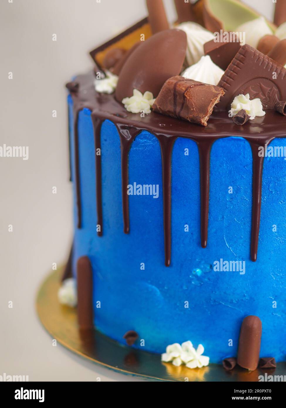 blue frosted icing cake macro close up with dark chocolate icing and ...