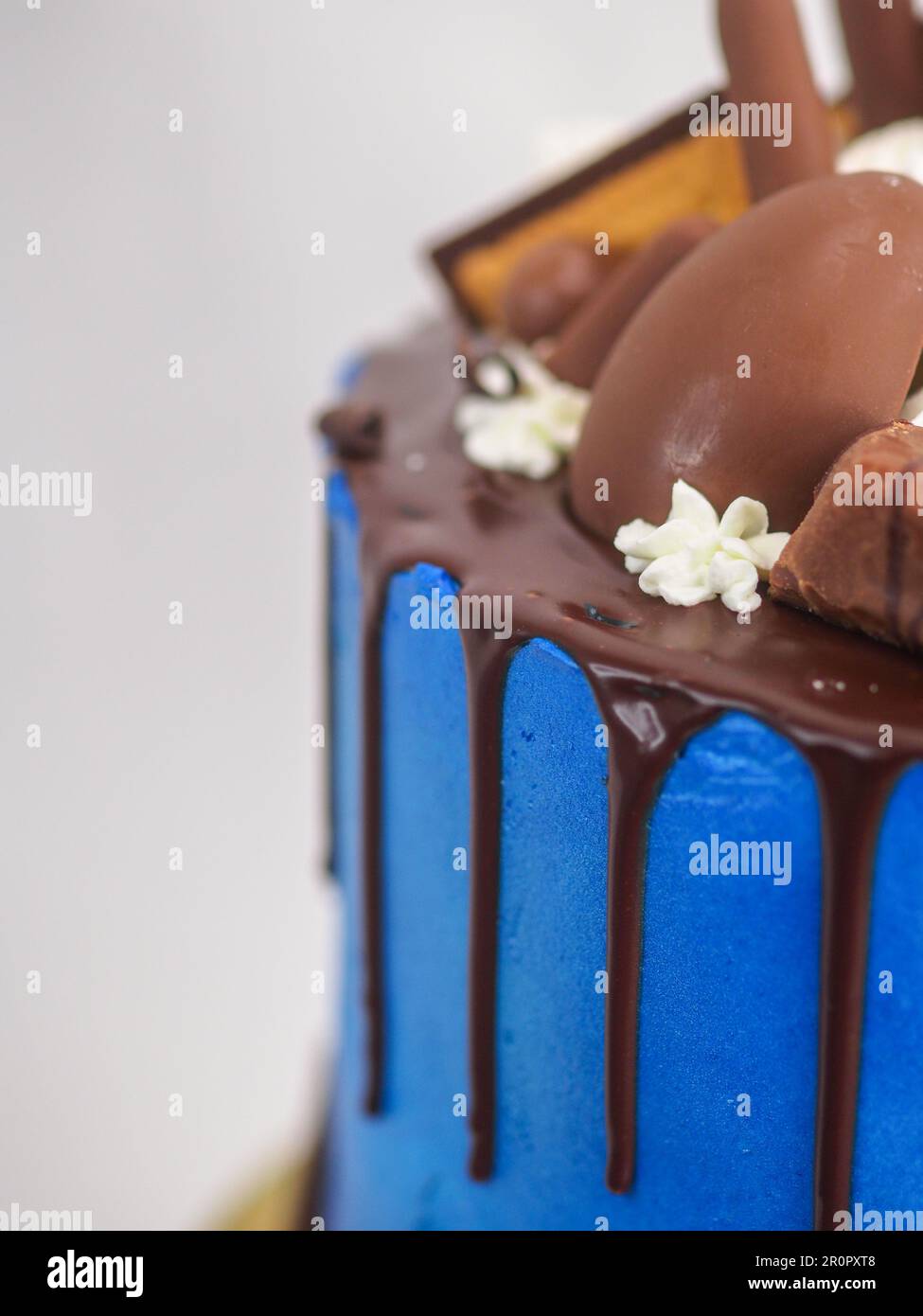 blue frosted icing cake macro close up with dark chocolate icing and ...