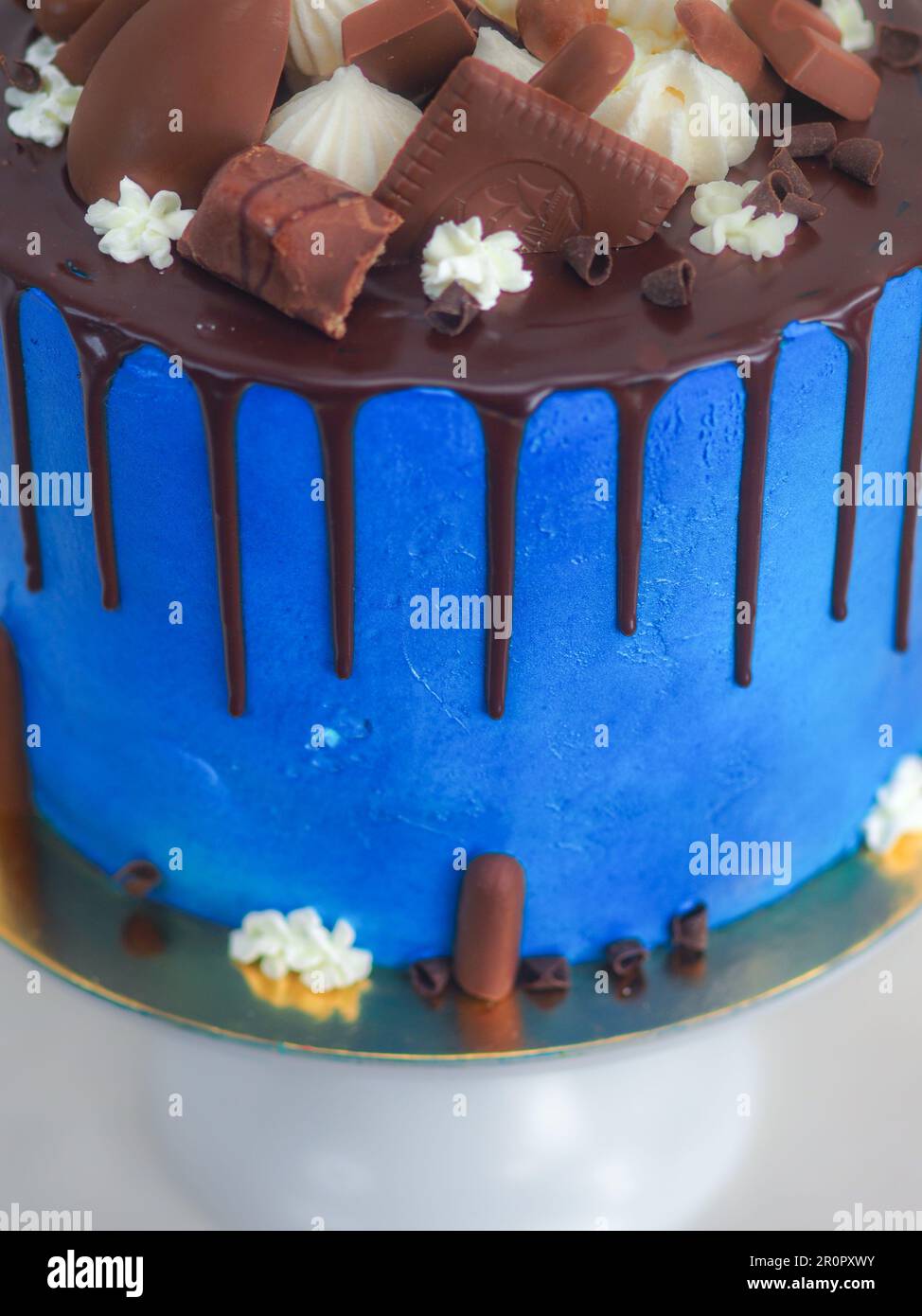 blue frosted icing cake macro close up with dark chocolate icing and ...