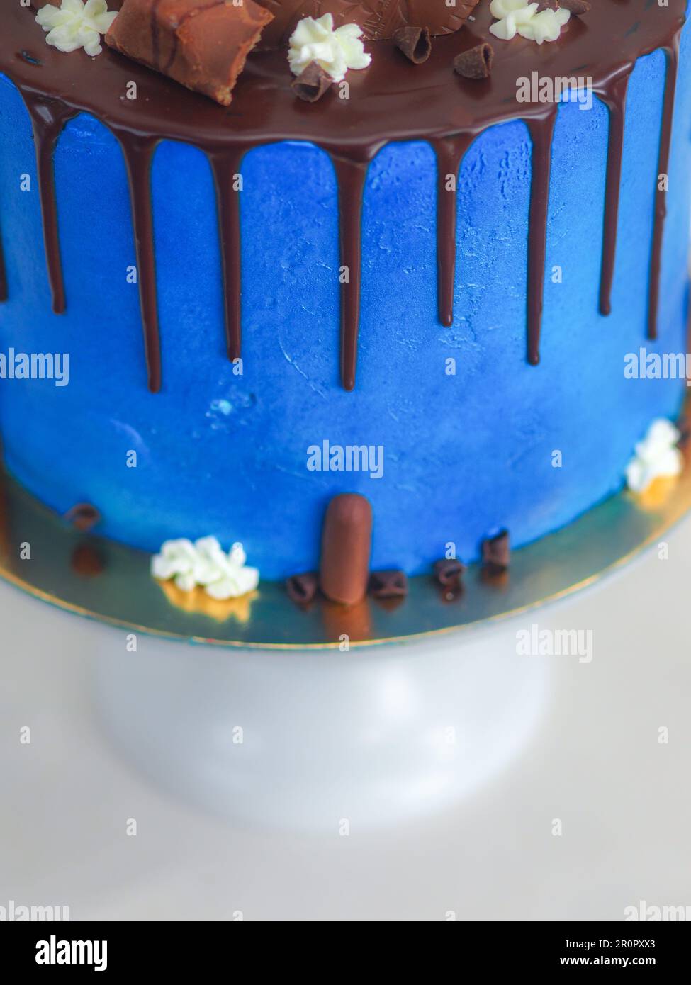 blue frosted icing cake macro close up with dark chocolate icing and ...