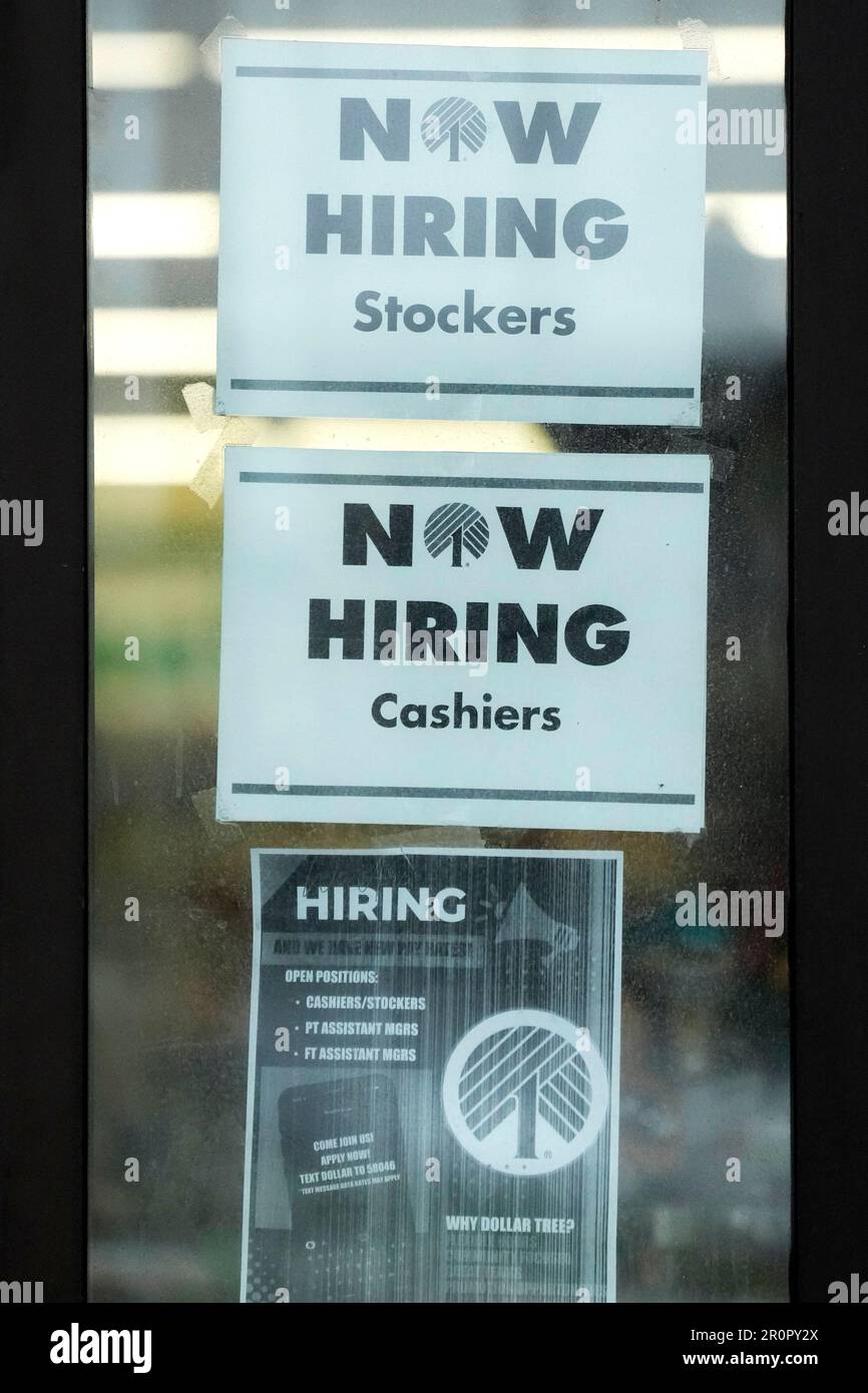 Hiring signs are displayed at a retail store in Downers Grove, Ill ...
