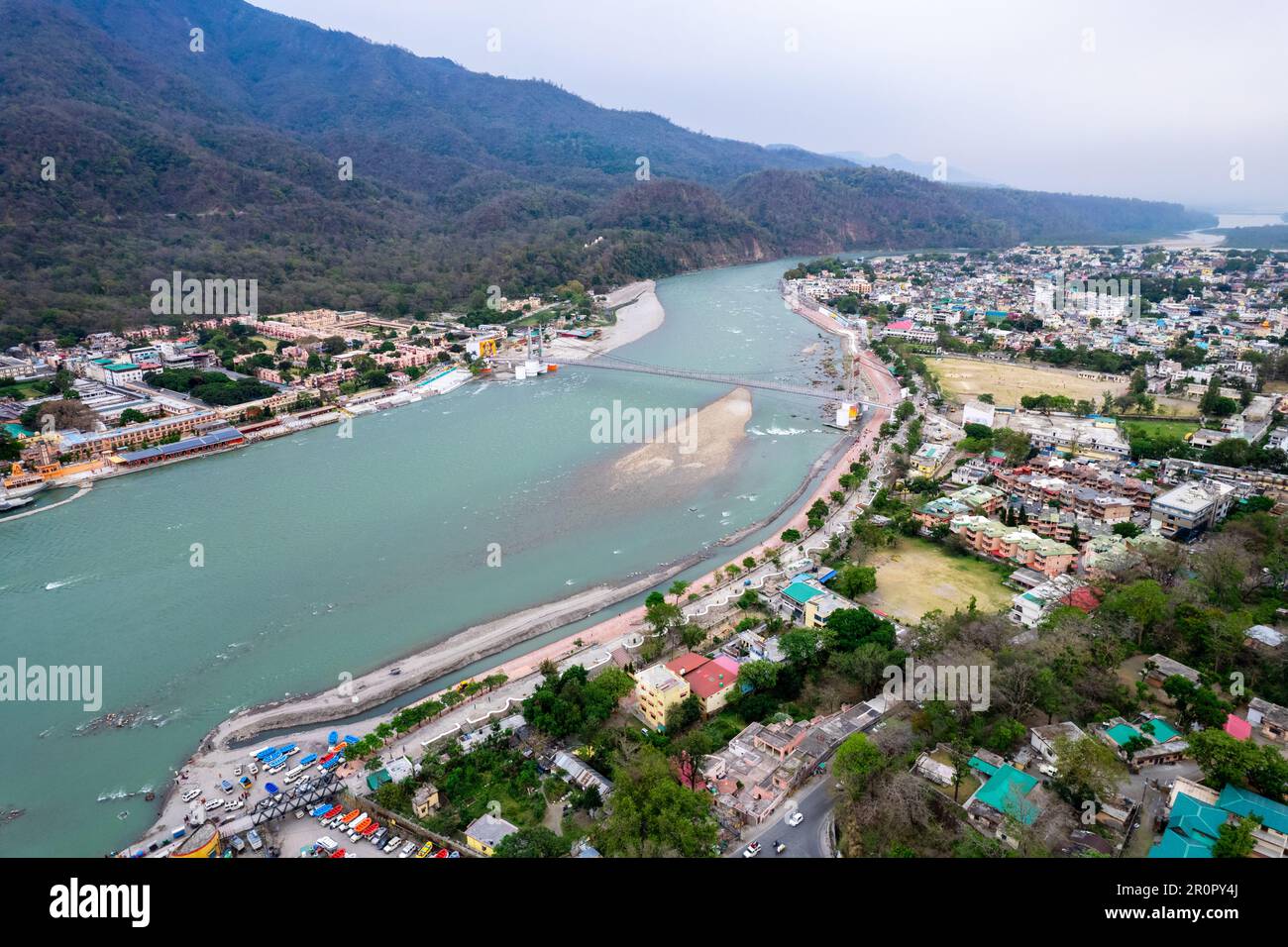 aerial drone shot over ram setu jhula suspension bridge with temples on ...