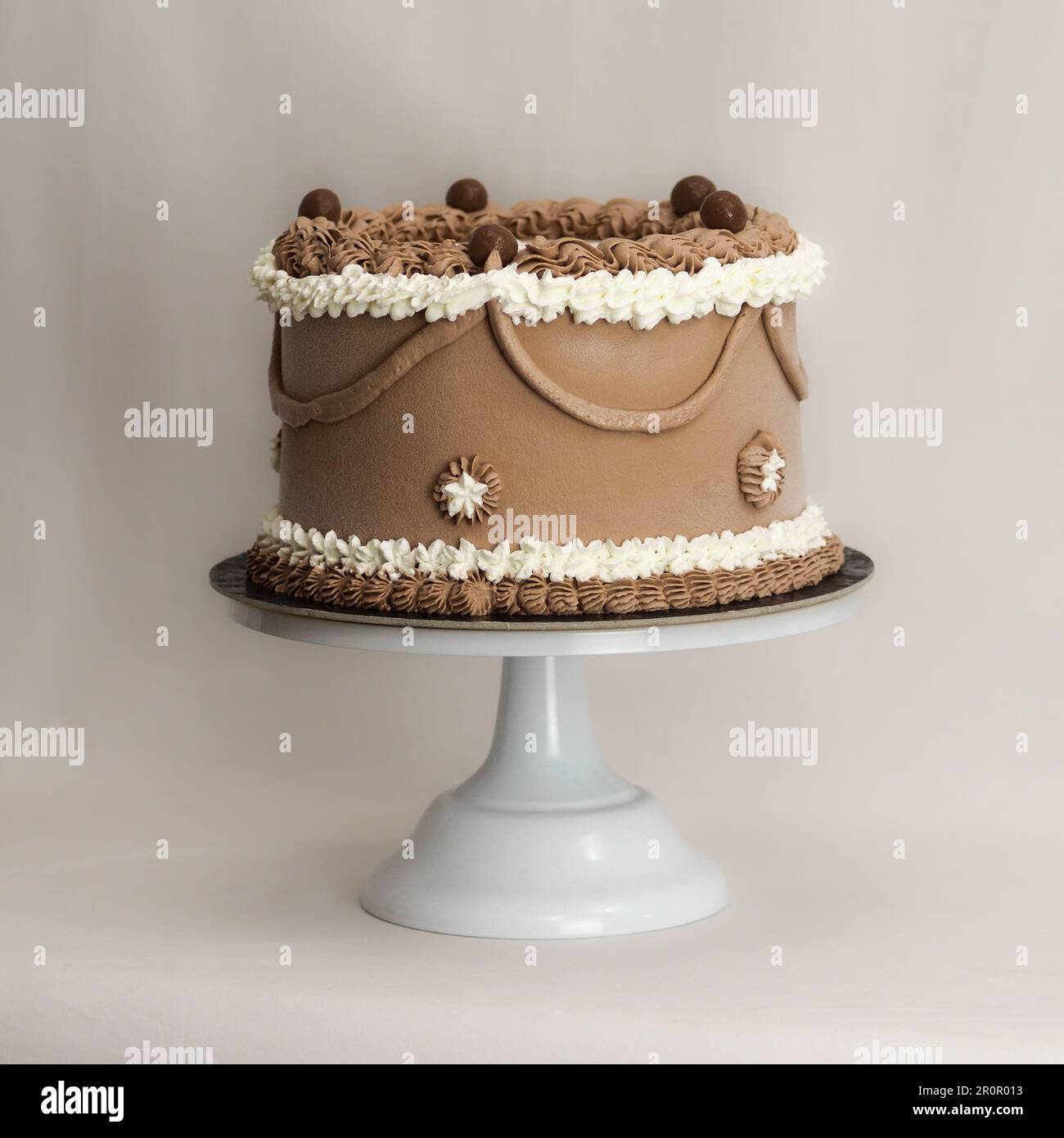 elegant beige brown frosted icing cake macro close up isolated on white ...