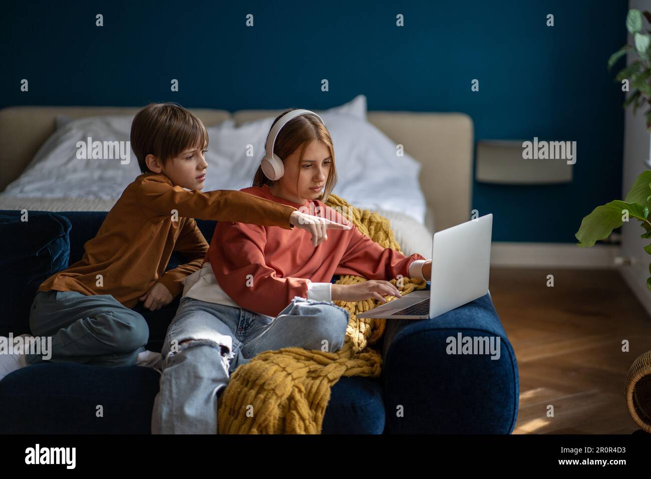 Teen girl and boy brother and sister watching movie together on laptop ...