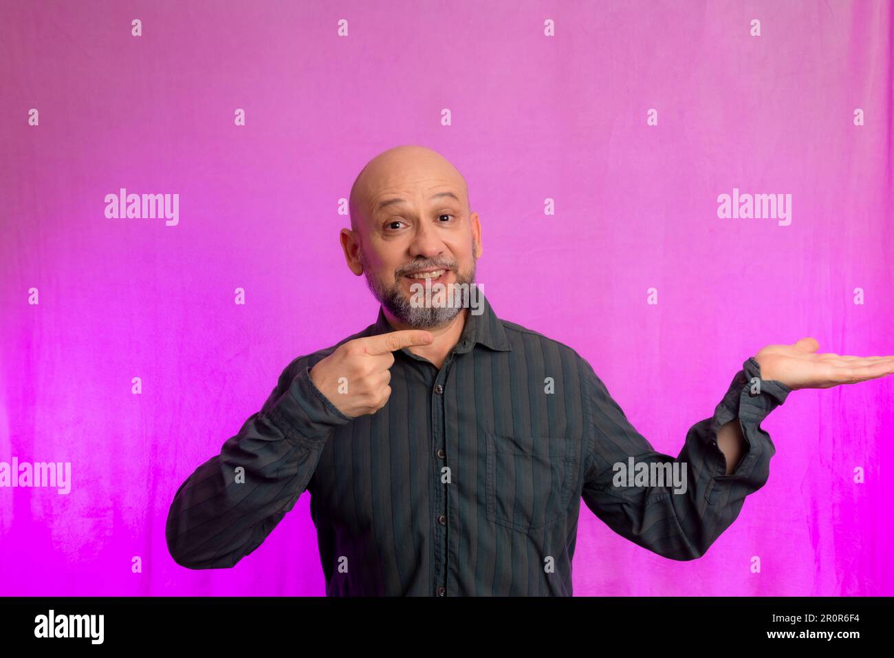 Portrait of serious man, 50 years old, with beard and bald head making ...