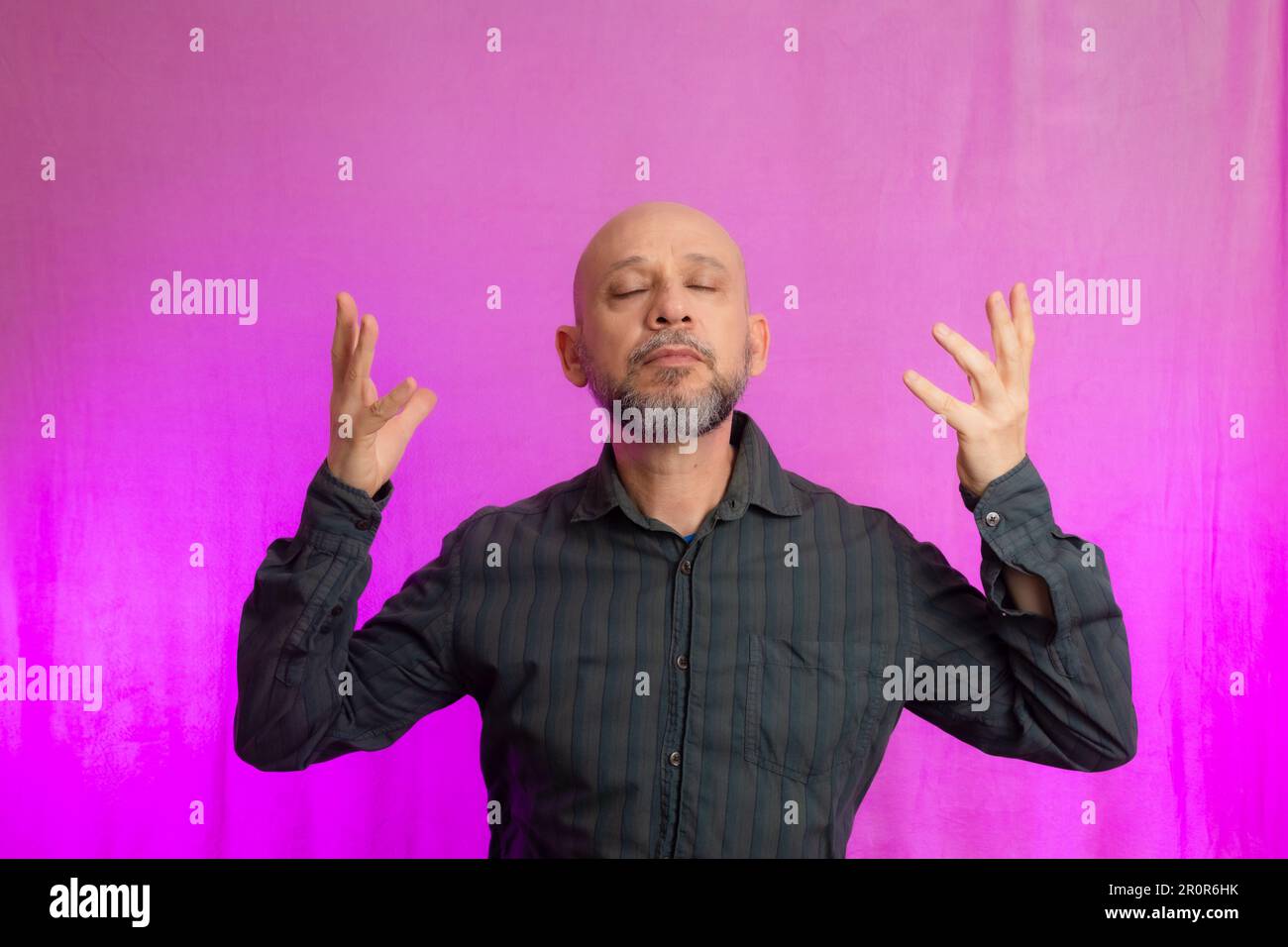 Portrait of serious man, 50 years old, with beard and bald head making ...
