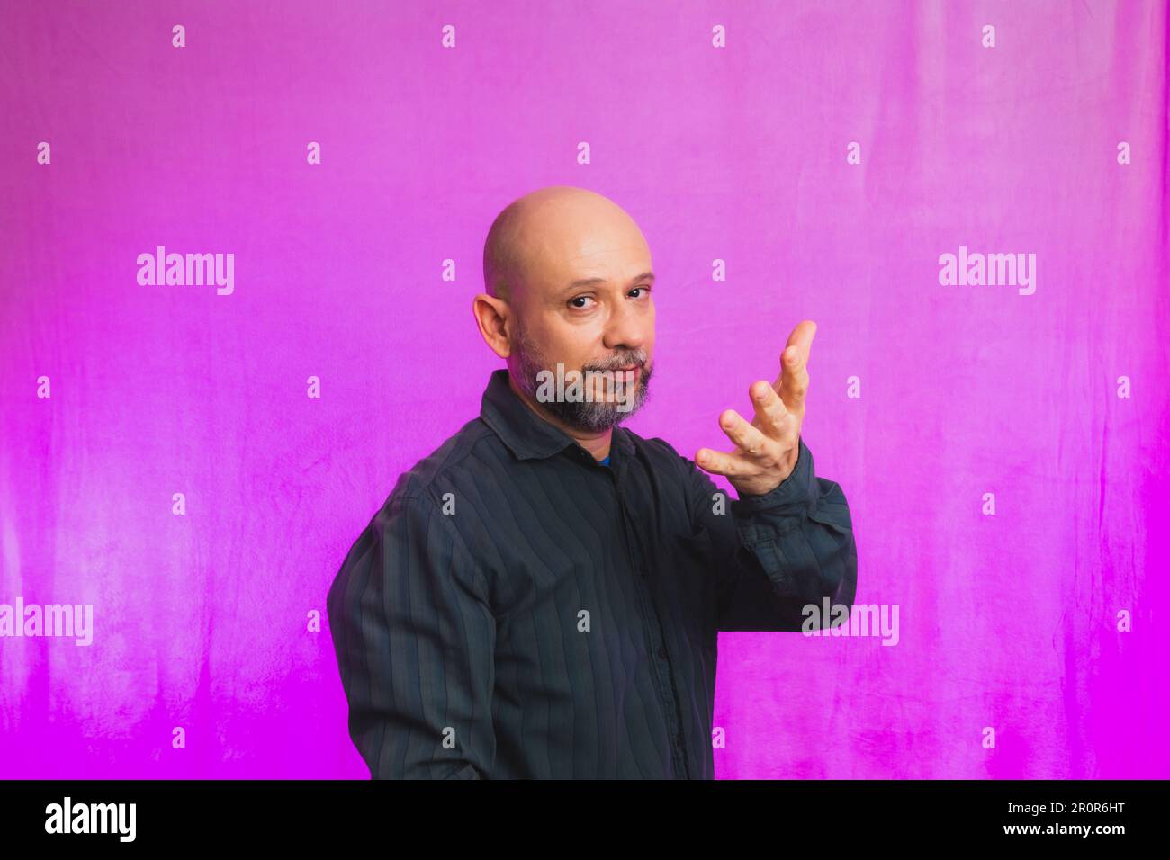 Portrait of serious man, 50 years old, with beard and bald head making ...