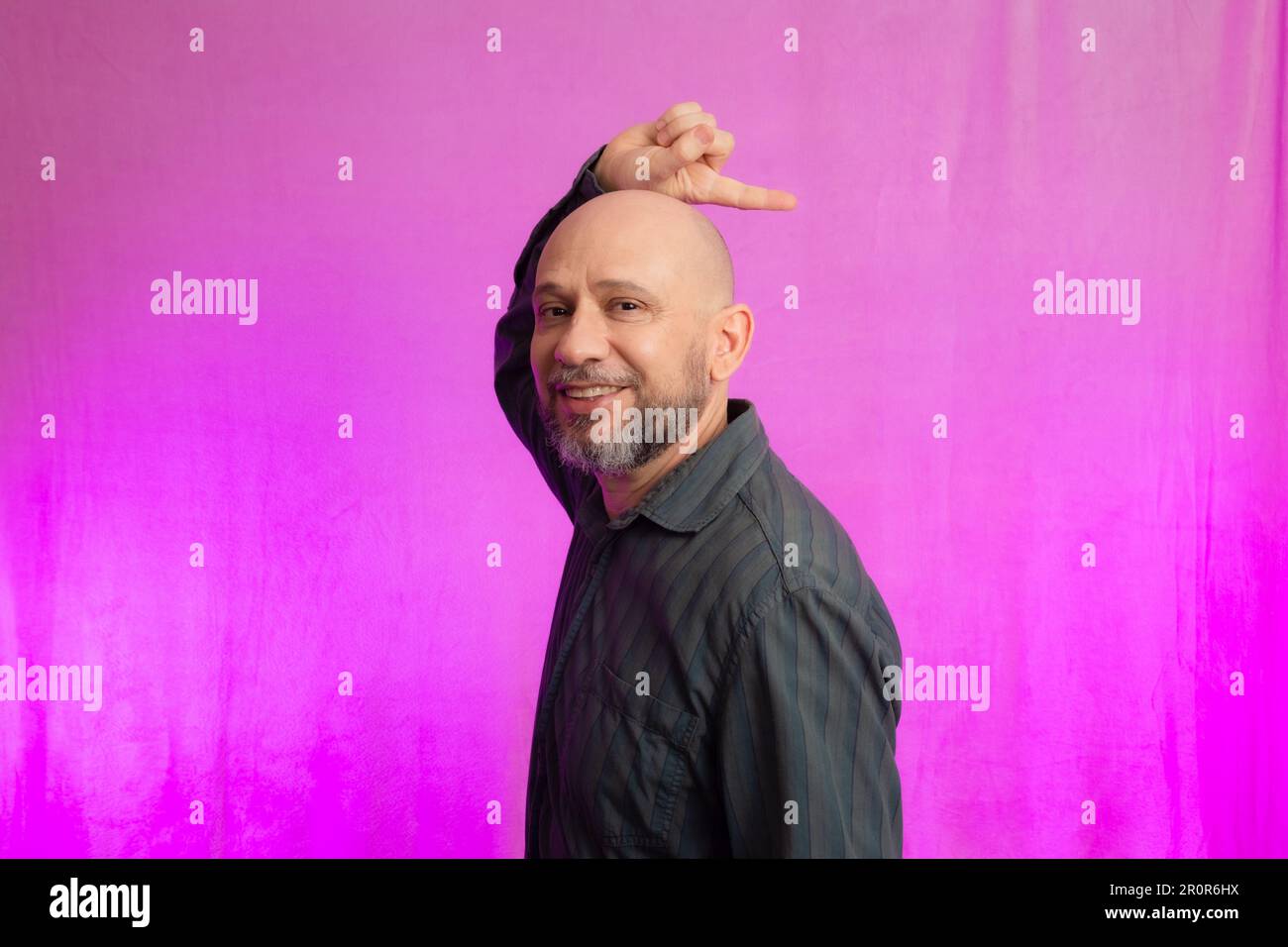 Portrait of serious man, 50 years old, with beard and bald head making ...