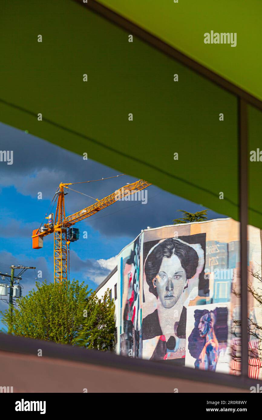Public mural art reflected in the window of a building in the Mount ...