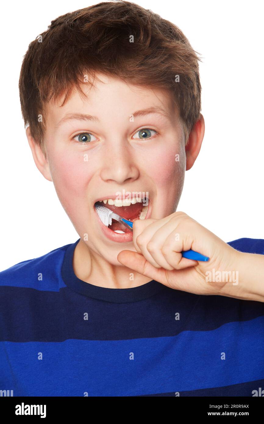 Face, smile and child brushing teeth in studio isolated on a white ...