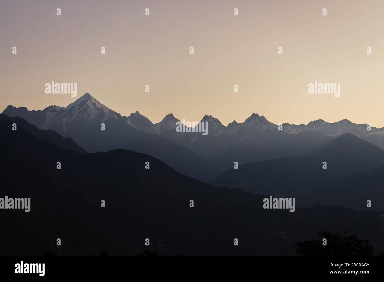Himalayan landscape in sunrise light. Snow-capped peaks in early ...