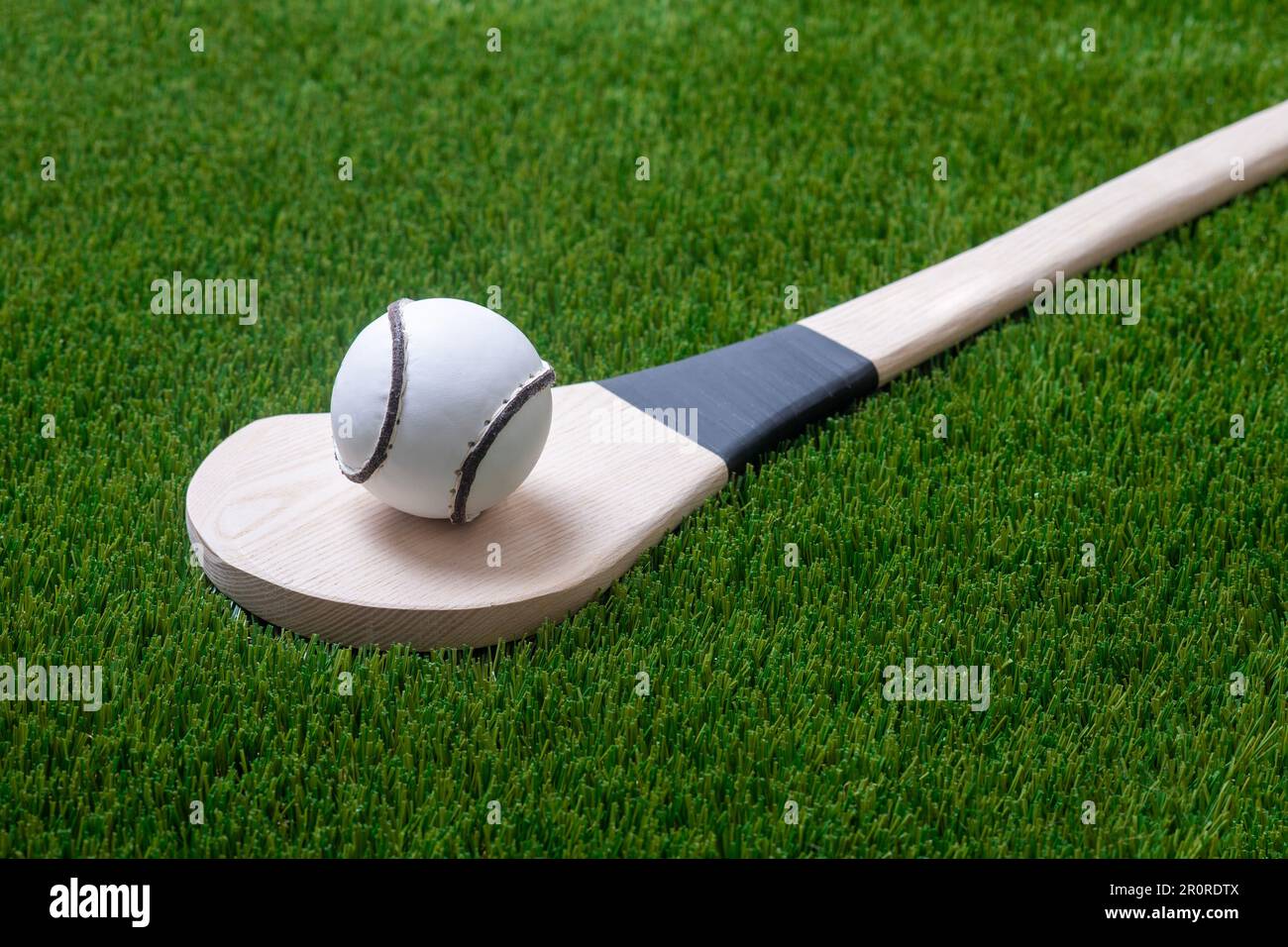 Hurling bat and sloitar on green grass. Horizontal sport theme poster ...