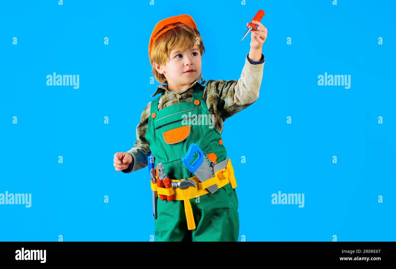 Boy in safety helmet and toolbelt with screwdriver. Child game. Little ...