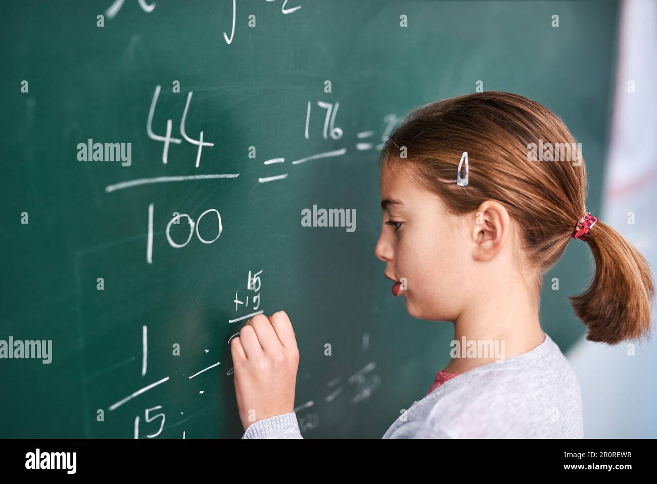 I hope this is right. a focussed young elementary school kid writing ...