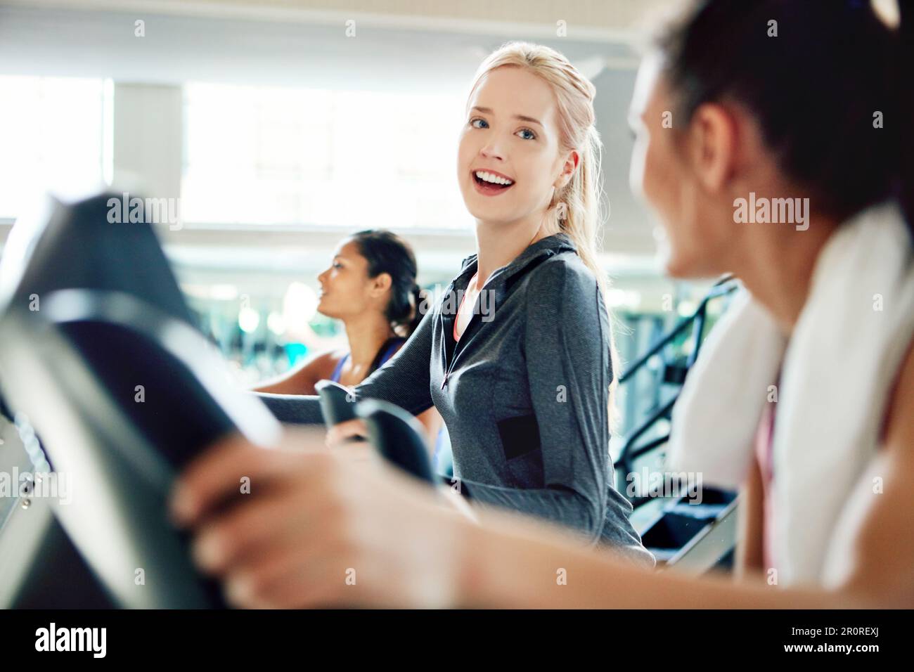 Youre on. attractive young women working out on treadmills at the gym ...