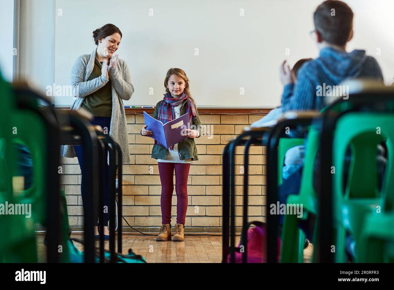 Well done. elementary school kids clapping in the classroom Stock Photo ...