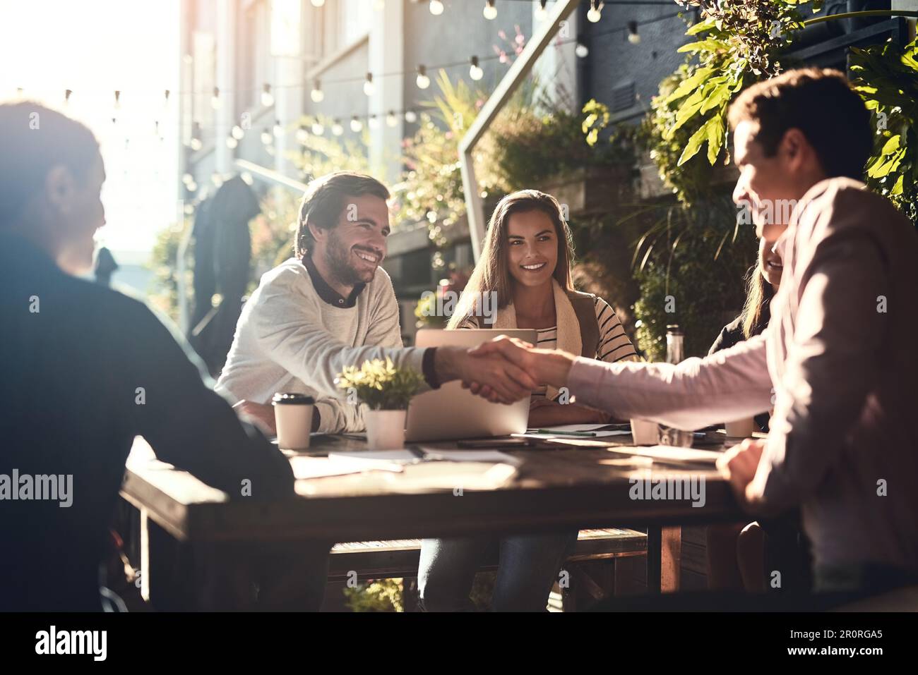They sealed the deal over lunch. colleagues shaking hands during a ...