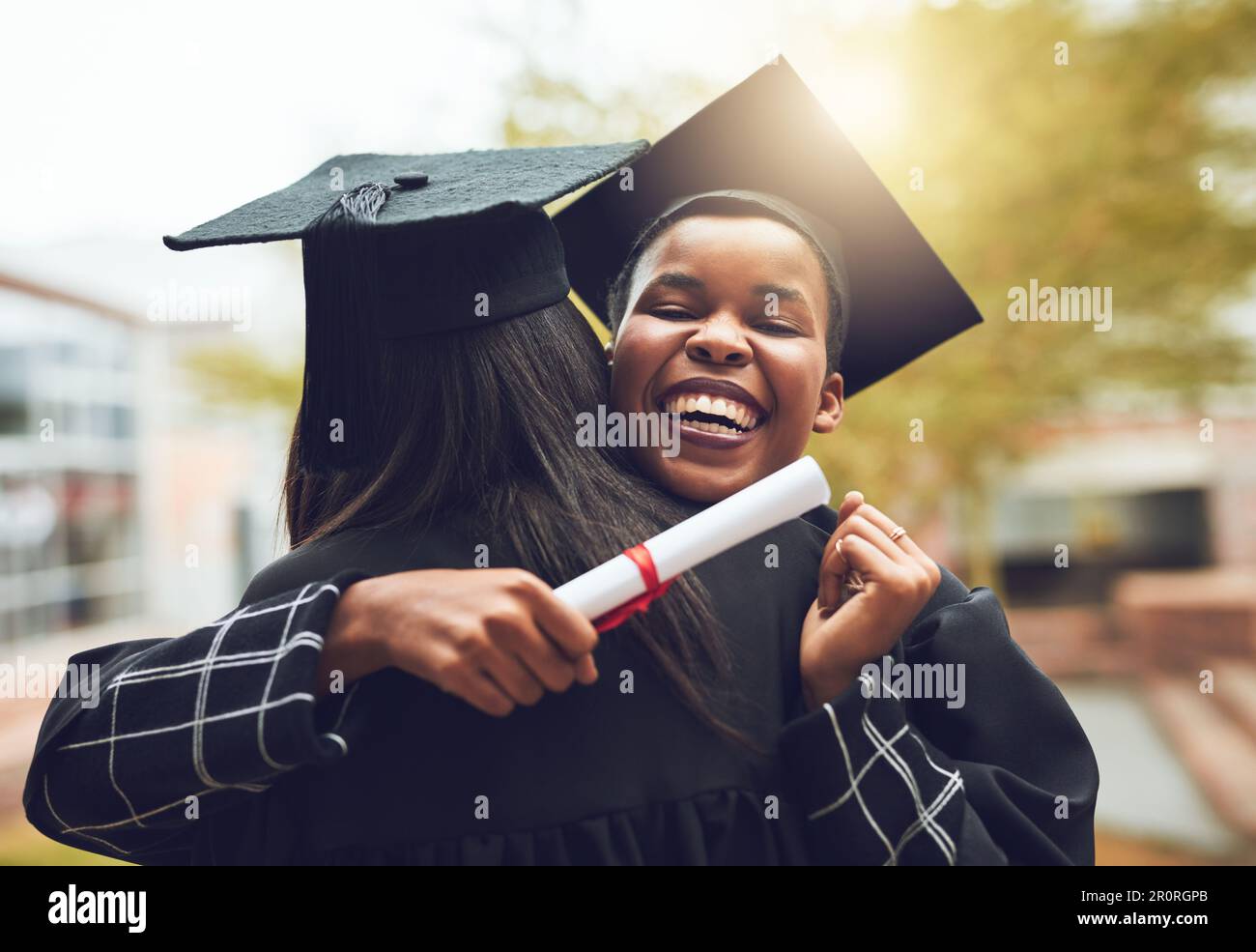 I cant believe we finally made it. two graduates embracing each other ...