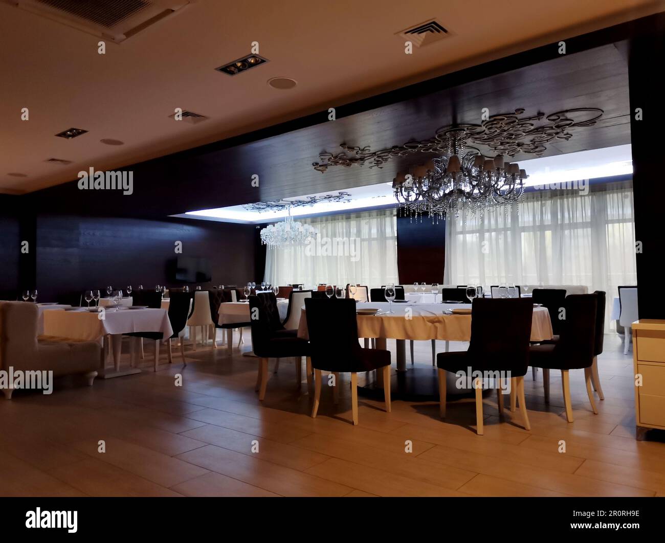 Spacious restaurant hall interior detail with tables, chairs and ...