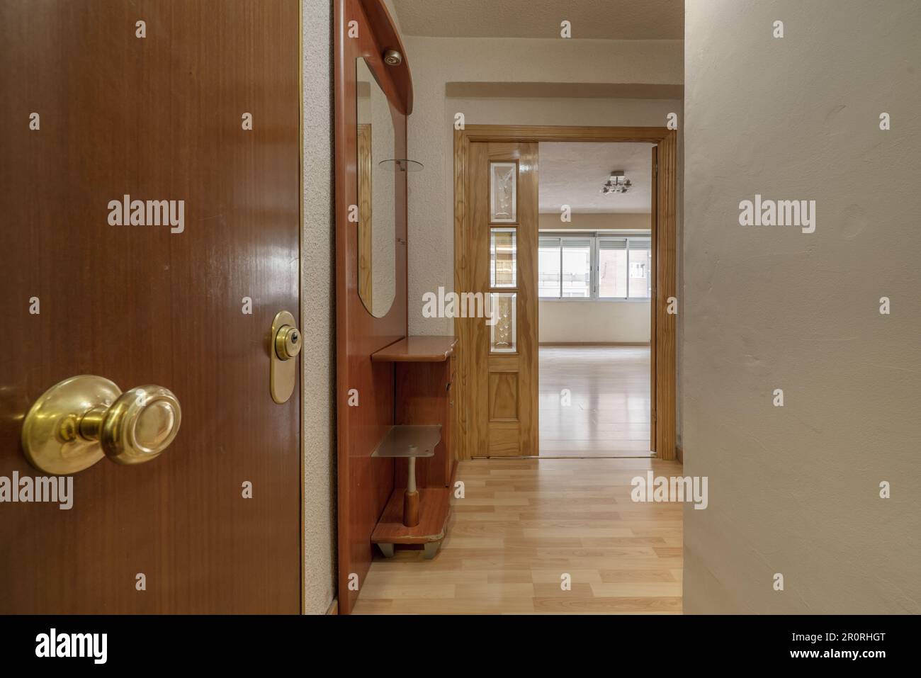 Hallway of a house with light wooden floors and matching wooden access ...