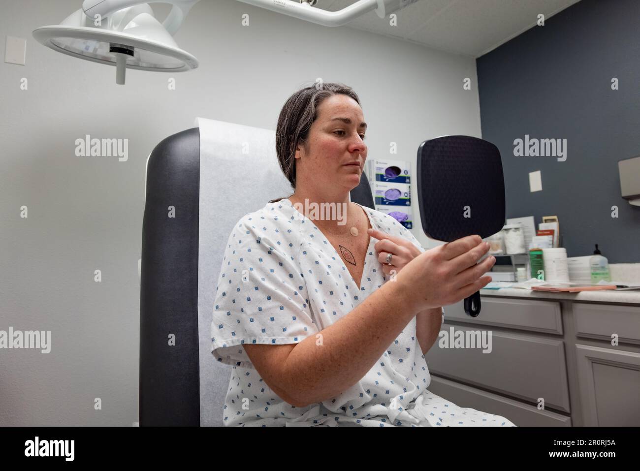 Horizontal image of young 30s dermatology patient examines possible ...