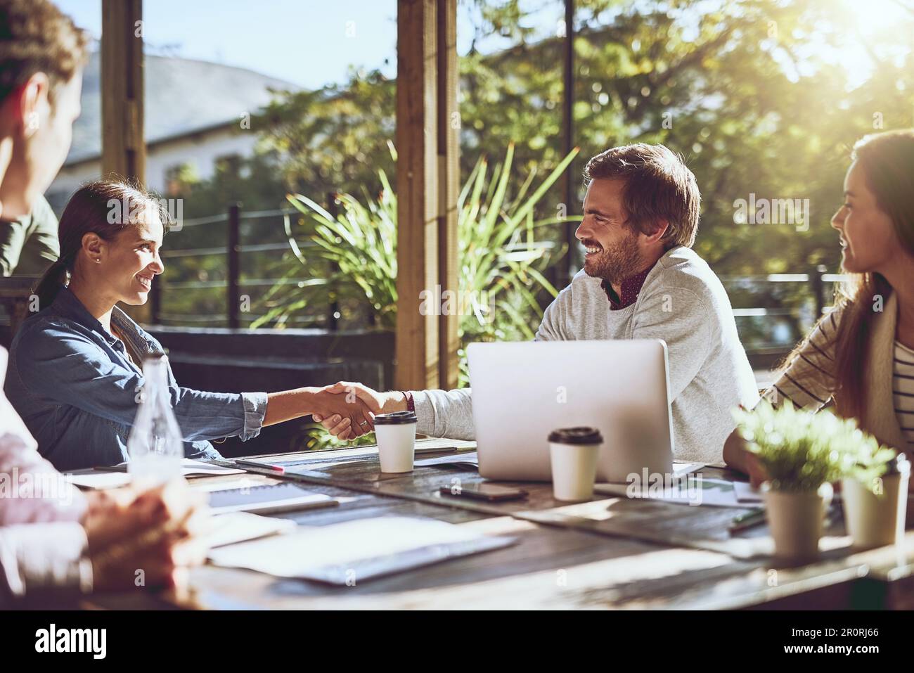 Youre already an integral part of the team. colleagues shaking hands ...