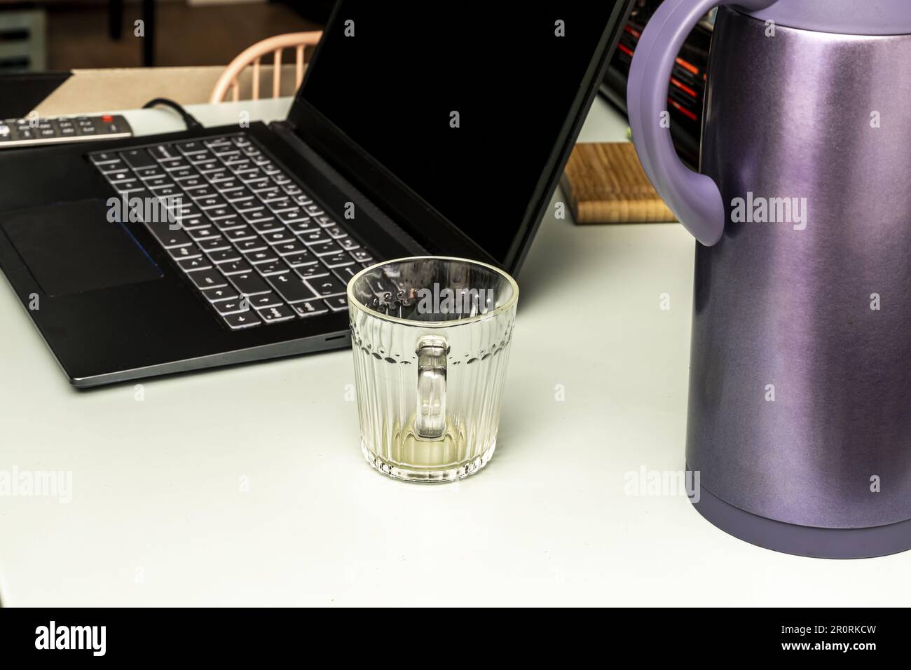 set with a laptop, a glass cup and a thermos with tea Stock Photo - Alamy