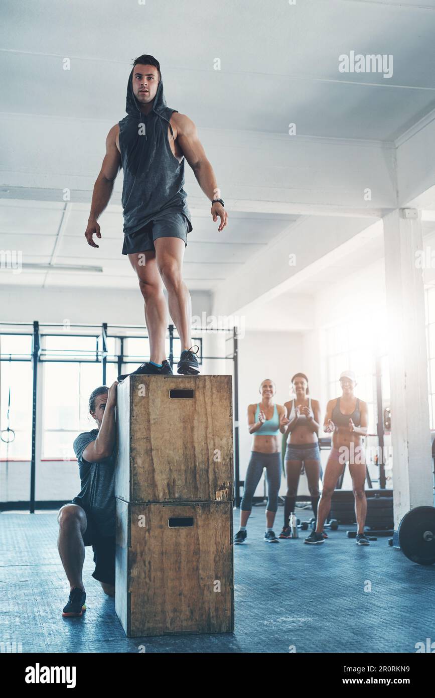 Youve got this. a man doing box jumps while others cheer him on Stock ...